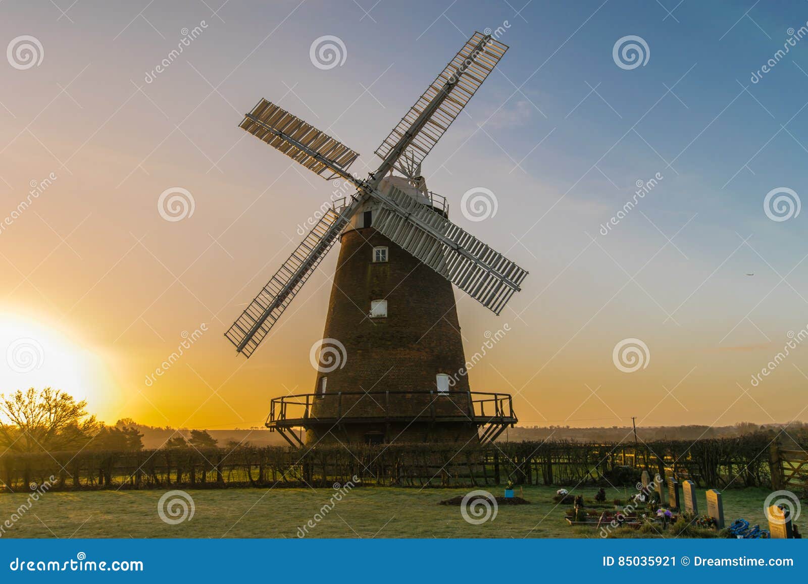 Windmill at sunrise stock image. Image of renewable, british - 85035921