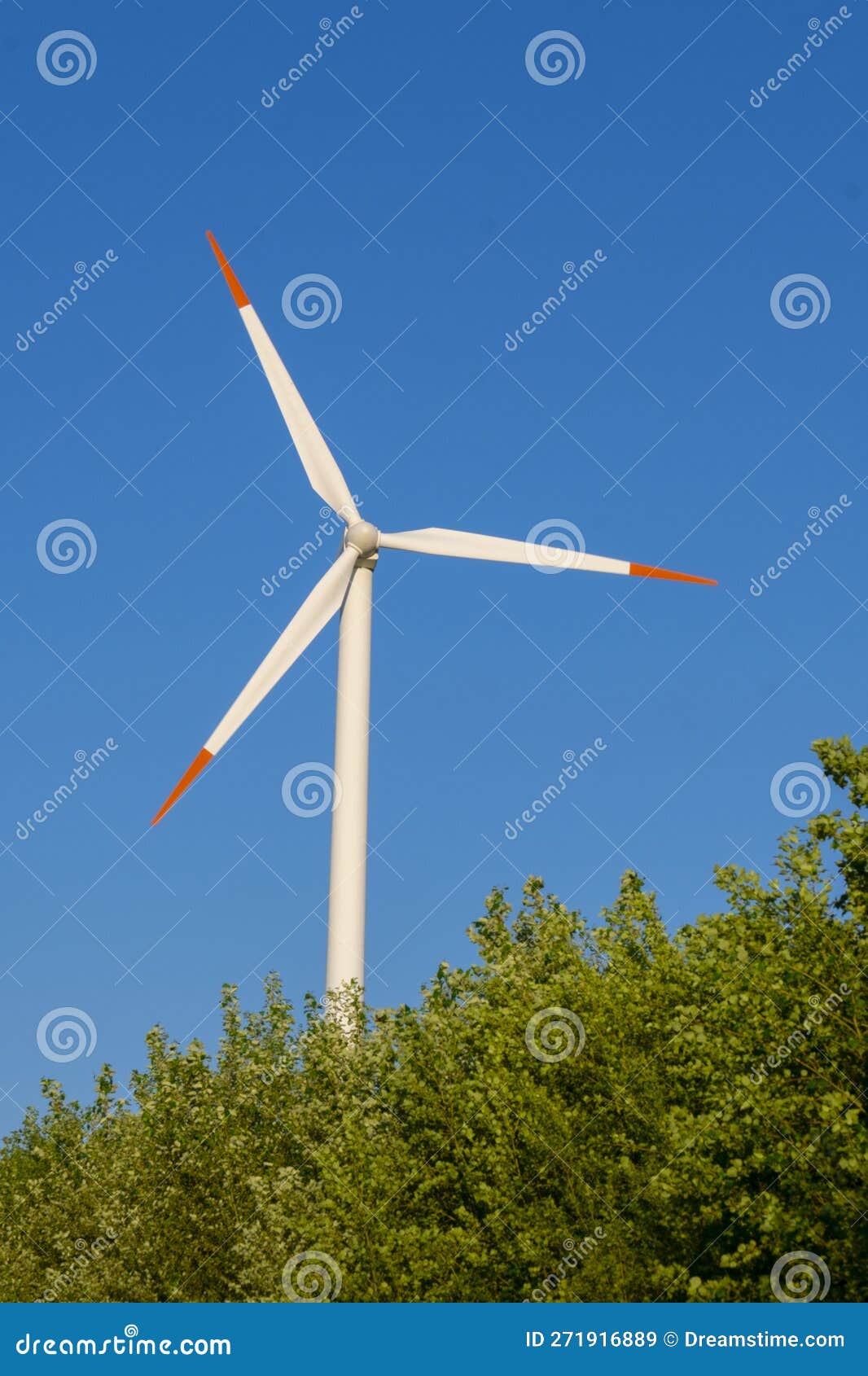 Windmill in Tree Branches on Blue Sky Background.renewable Energy Stock ...