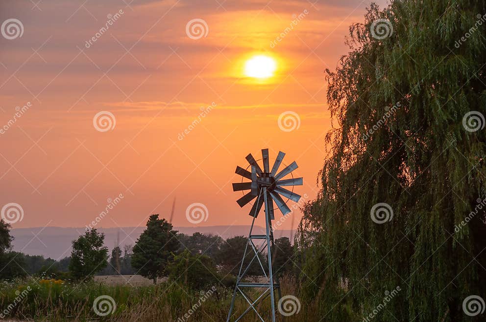 A Windmill beside a Willow Tree during a Stunning Sunset Stock Image - Image of farm, industry ...