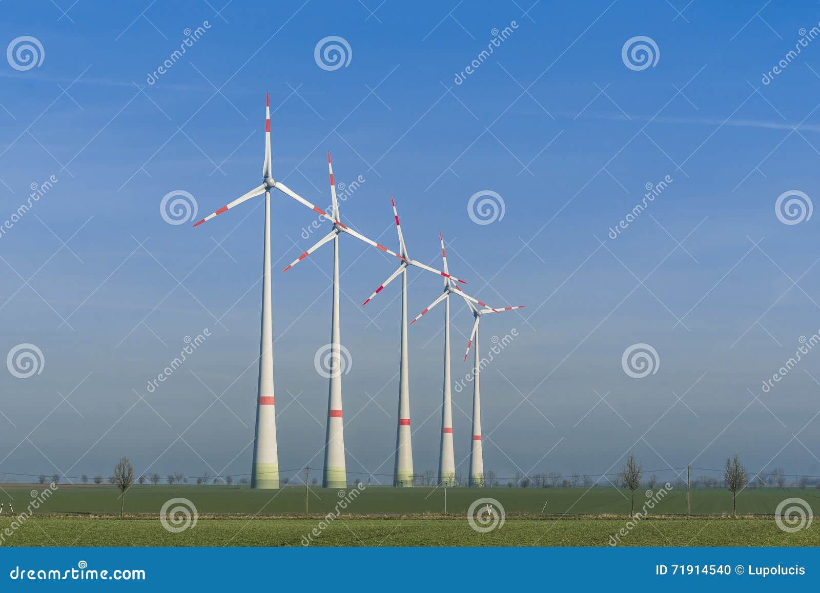 Windmills in a row stock photo. Image of force, energy - 71914540