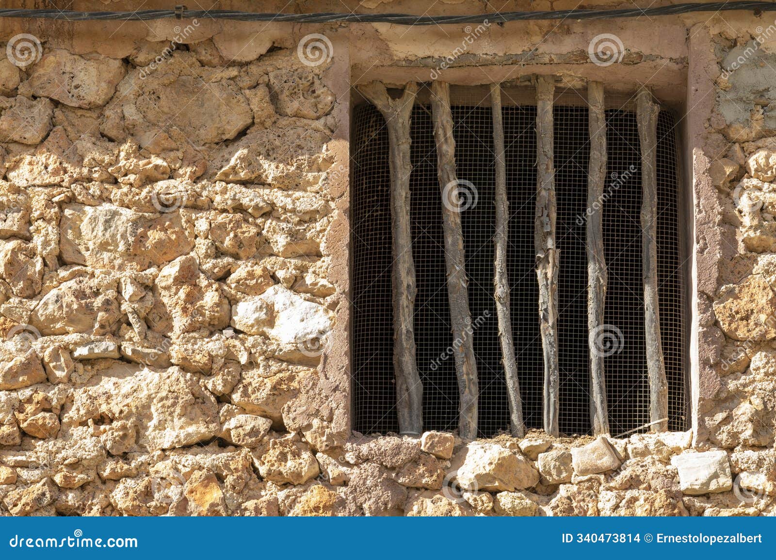 A Window with Bars on it is Shown in a Stone Building Stock Photo ...