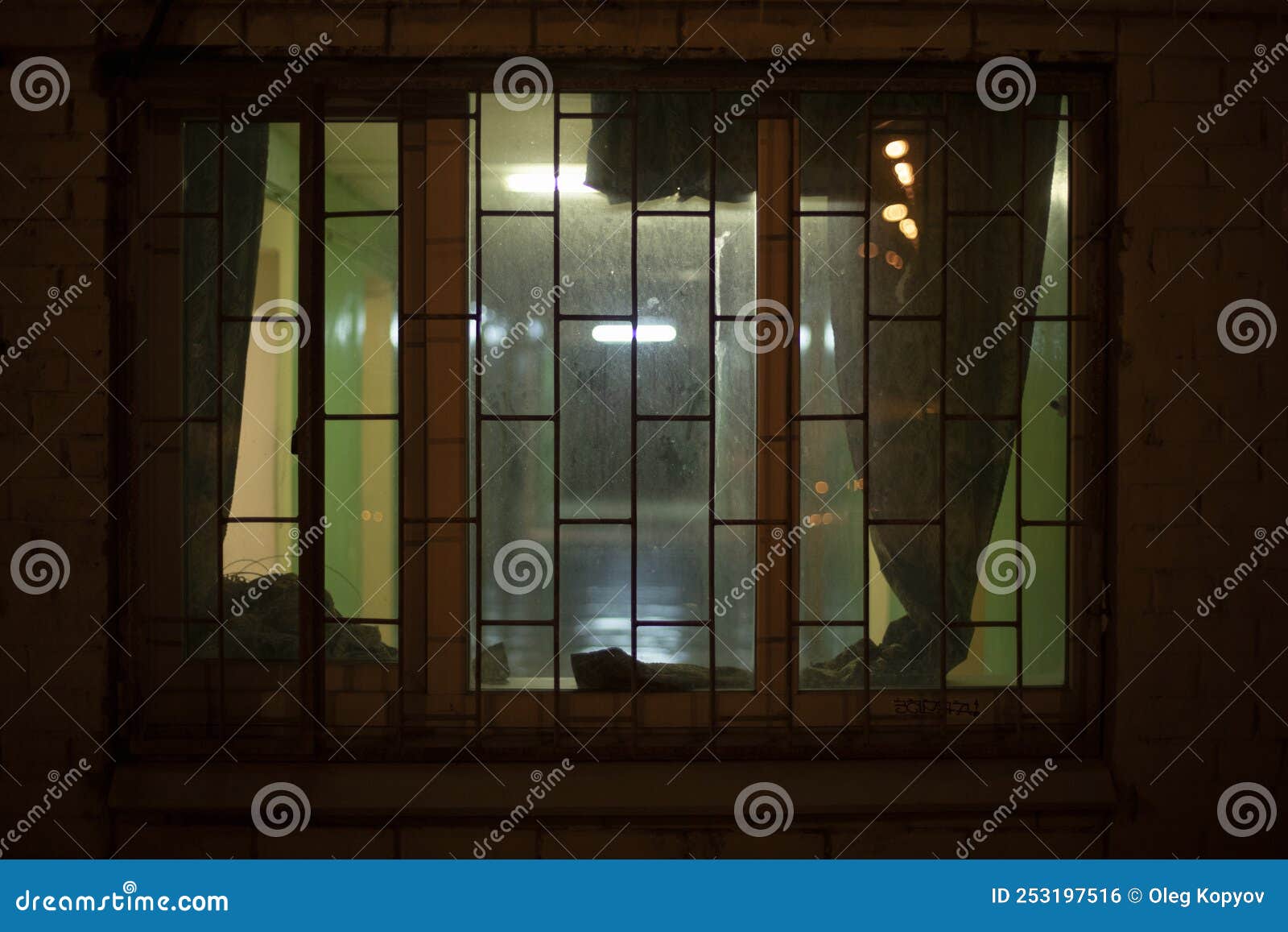 Window in Building in Evening. Grille on Window at Night Stock Photo ...