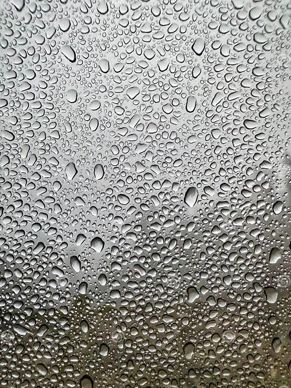 Window with Condensation Droplets on the Inside, Creating an Abstract ...