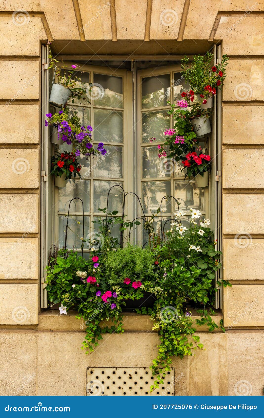 A Window Decorated with Flower Pots in Paris during Summer Stock Photo ...