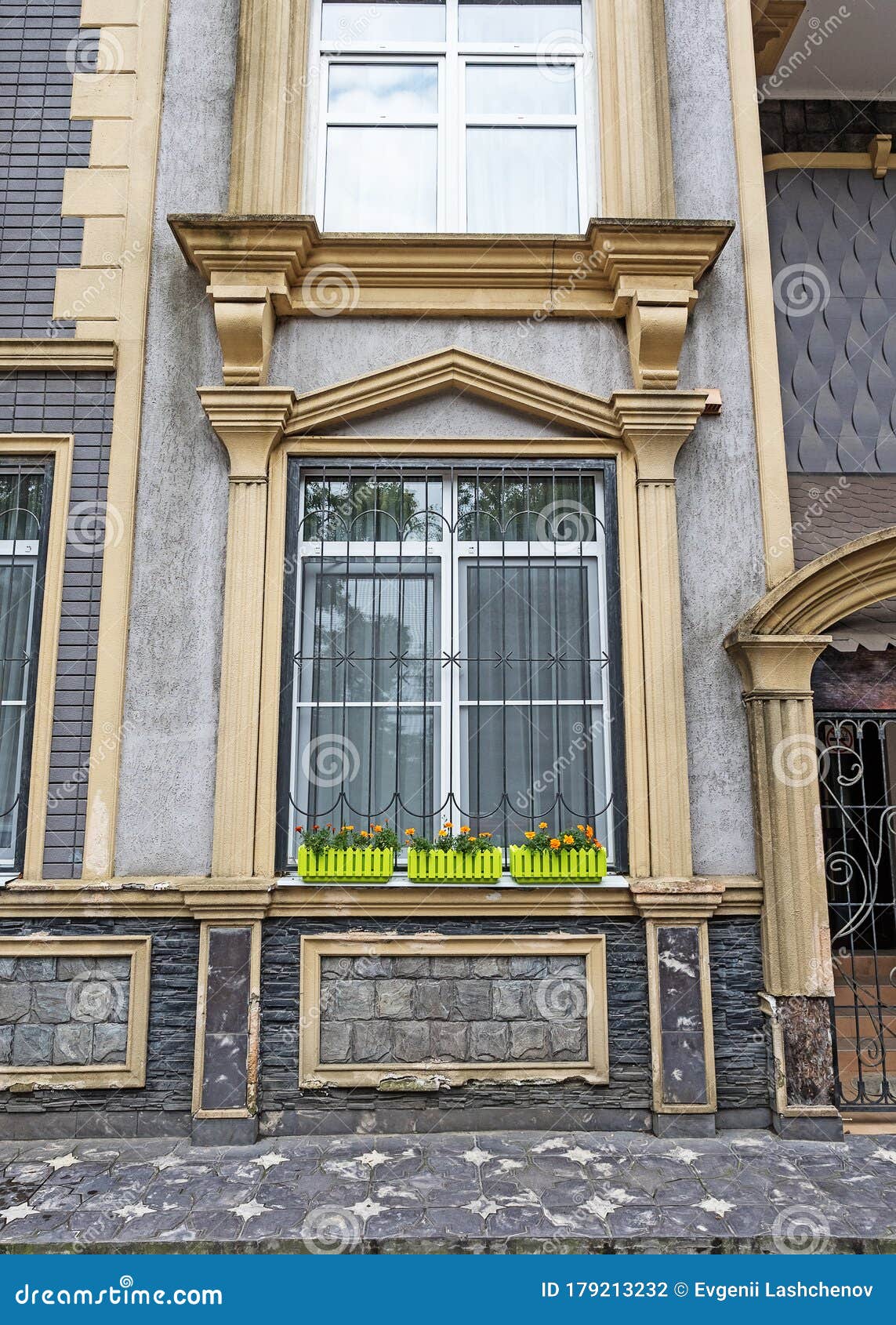 Window on the Facade of the Building with Decor and Flowers on the ...