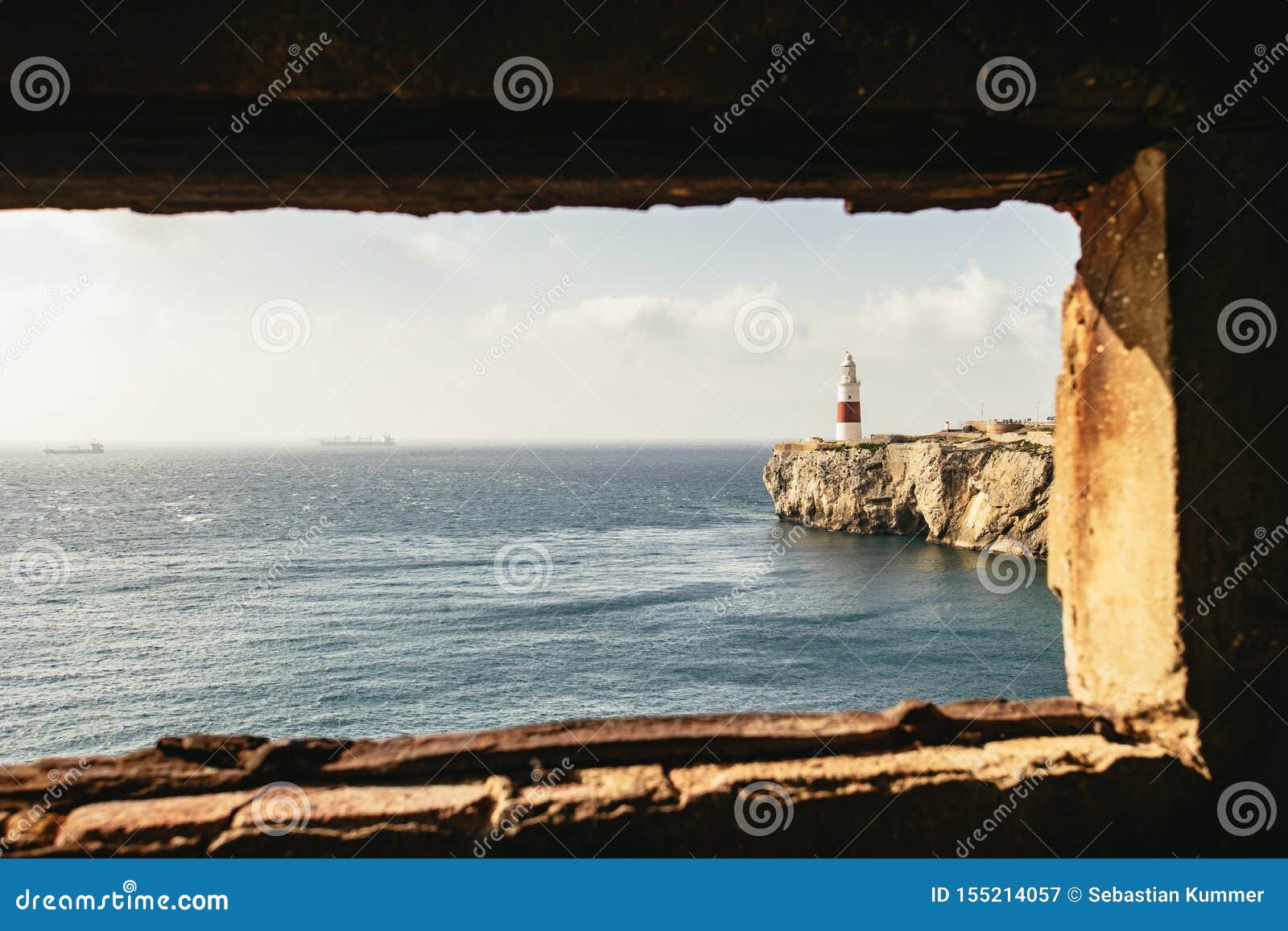Window in Foreground Providing View of Lighthouse Stock Image - Image ...