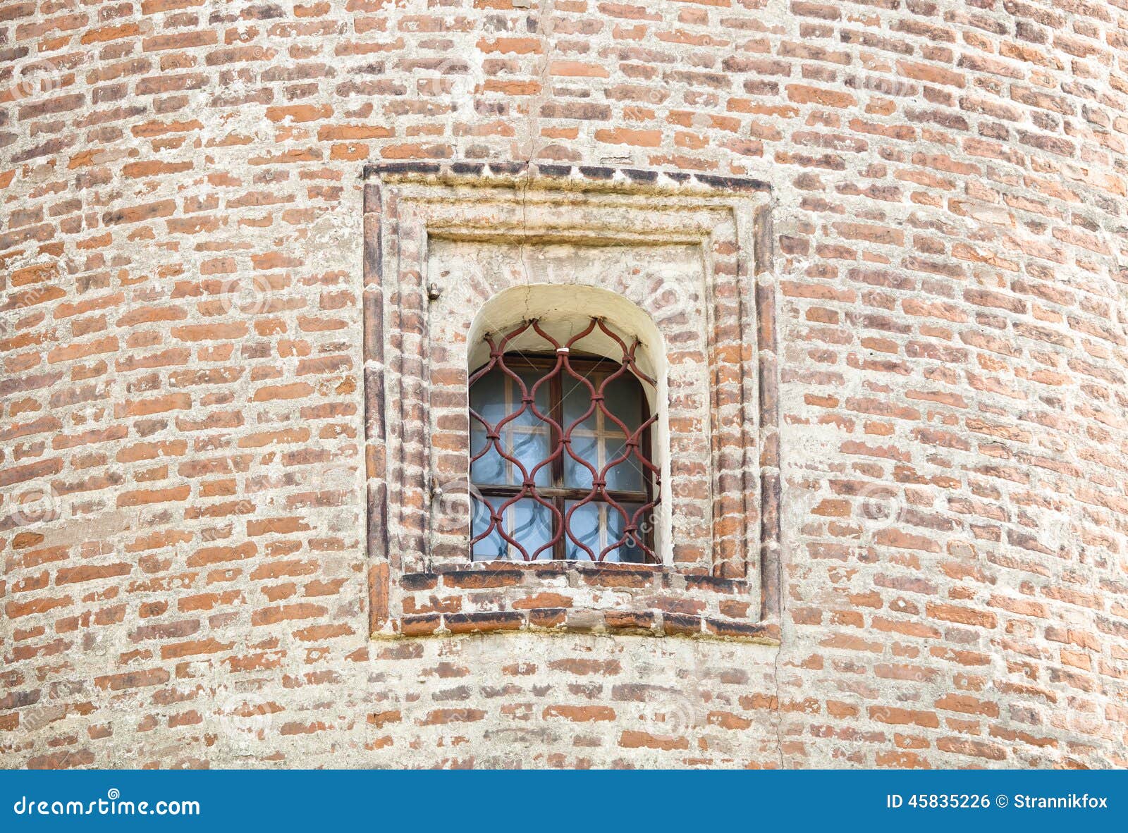 Window with Forged Bars in the Historic Tower Built of Red Brick Stock ...
