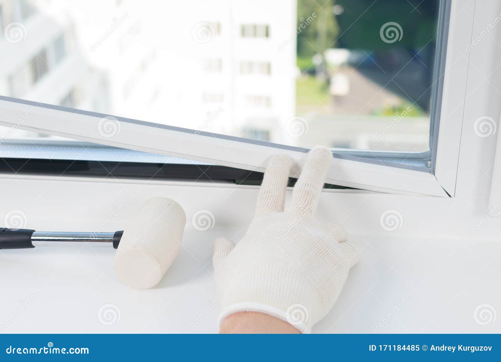 Window Installation Worker Inserts Glass into the Frame and Fastens it ...