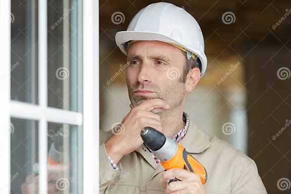 Window Installer in Contemplation Holding Drill Stock Image - Image of ...