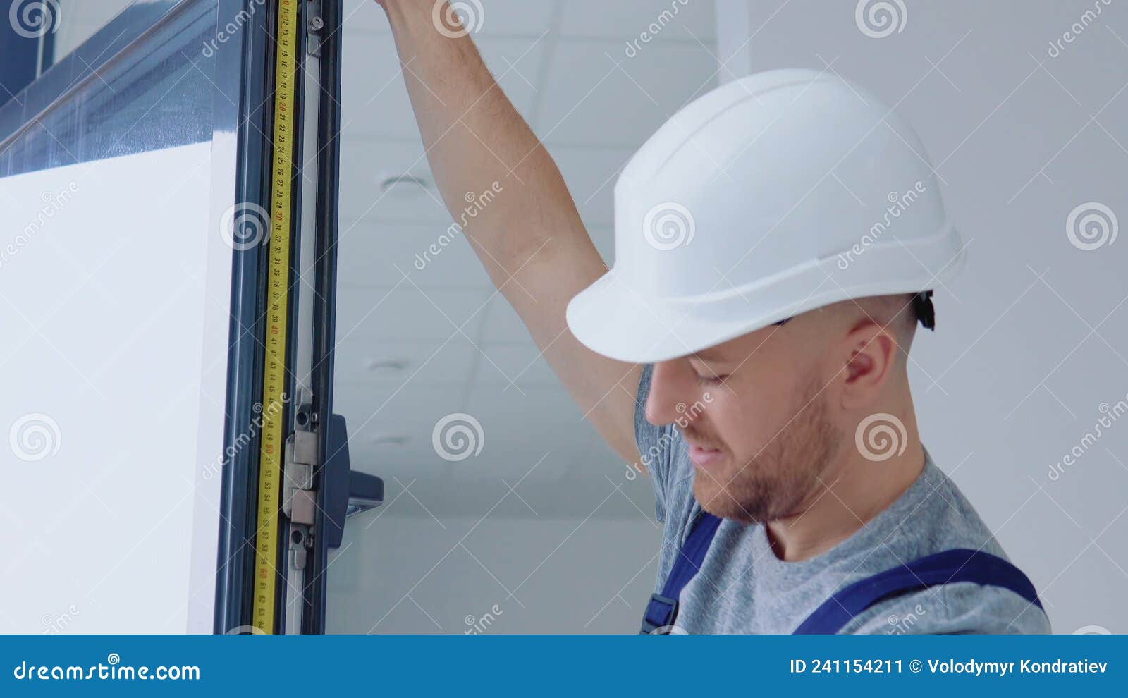 Window Installer Measures the Dimensions of the Window Frame with a ...