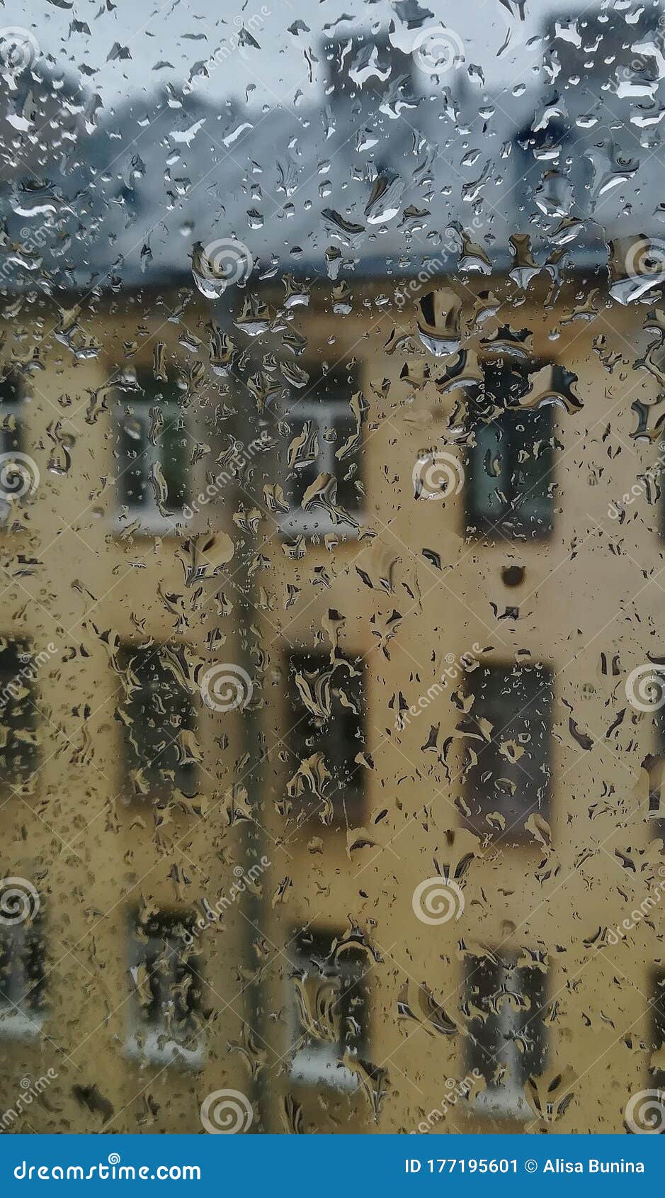 Window with Raindrops and View of the Old Building on a Cloudy Day ...