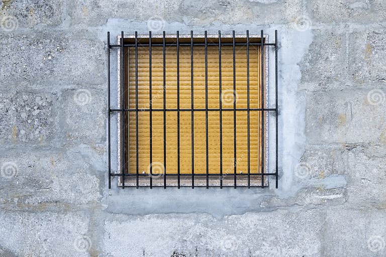 Window with the Shutter Down and Iron Bars on a Concrete Wall, Security ...