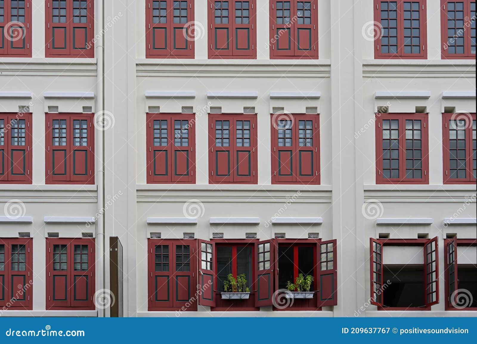 Facade of a Restored Building with Neat Rows of Brown Window Shutters ...