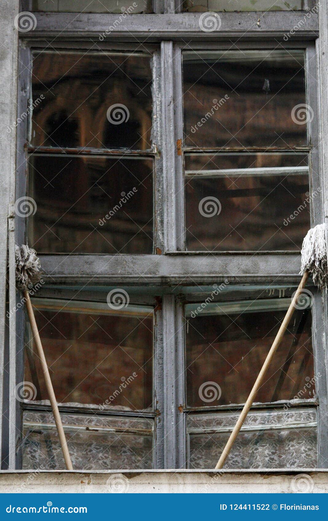 A Window with Two Cleaning Tools on Each Side. Urban Scene. Old ...