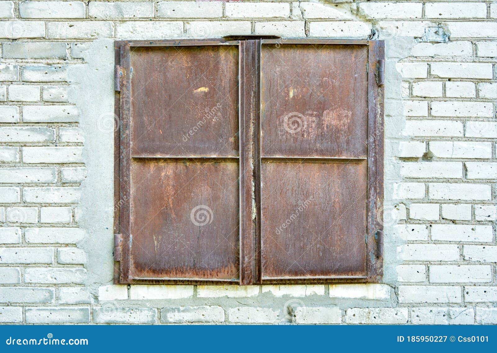 Window for Unloading Goods Closed by Rusty Iron Shutters on White Brick ...