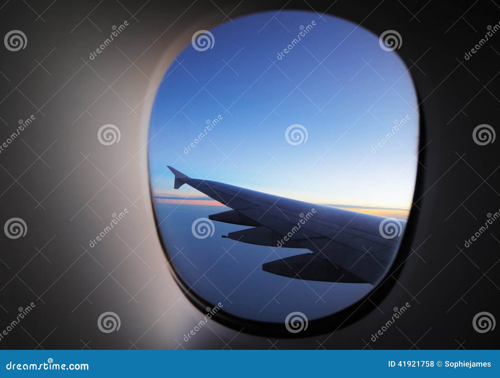View On Passenger Aircraft Right Wing. Sunset Shines As A Golden Light ...