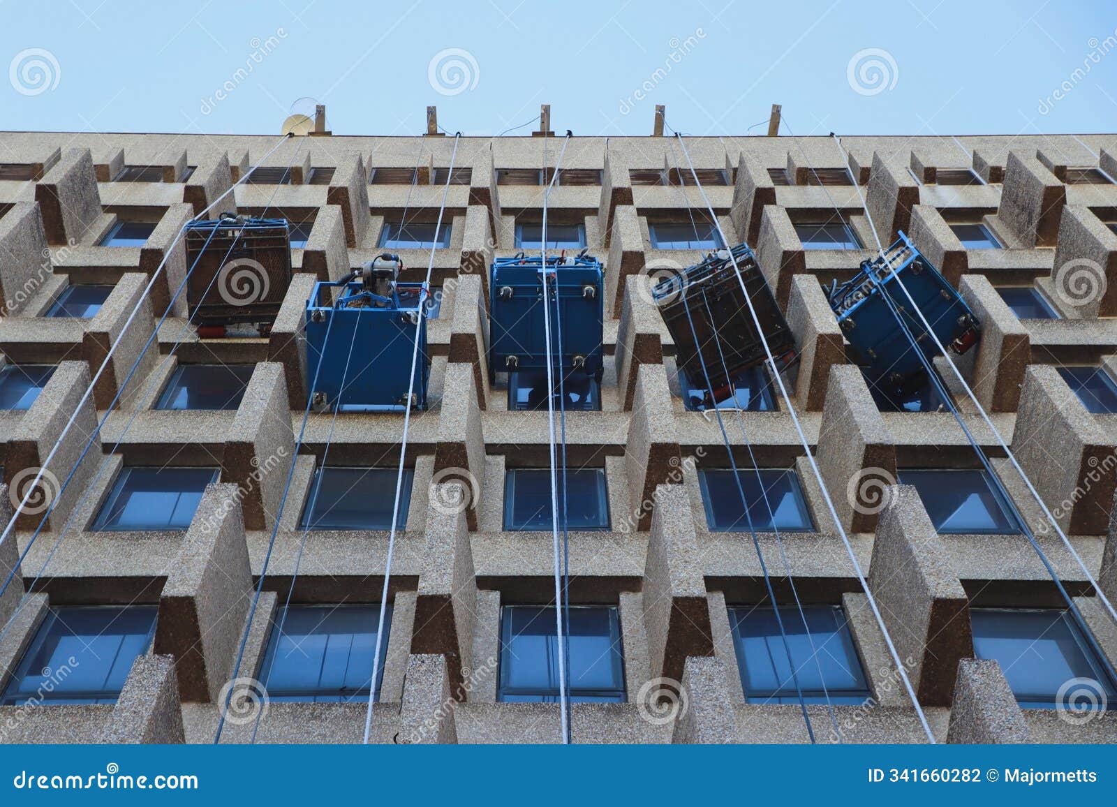 Window Washer Carts on Ropes Against Cement Building, Horizontal Stock ...