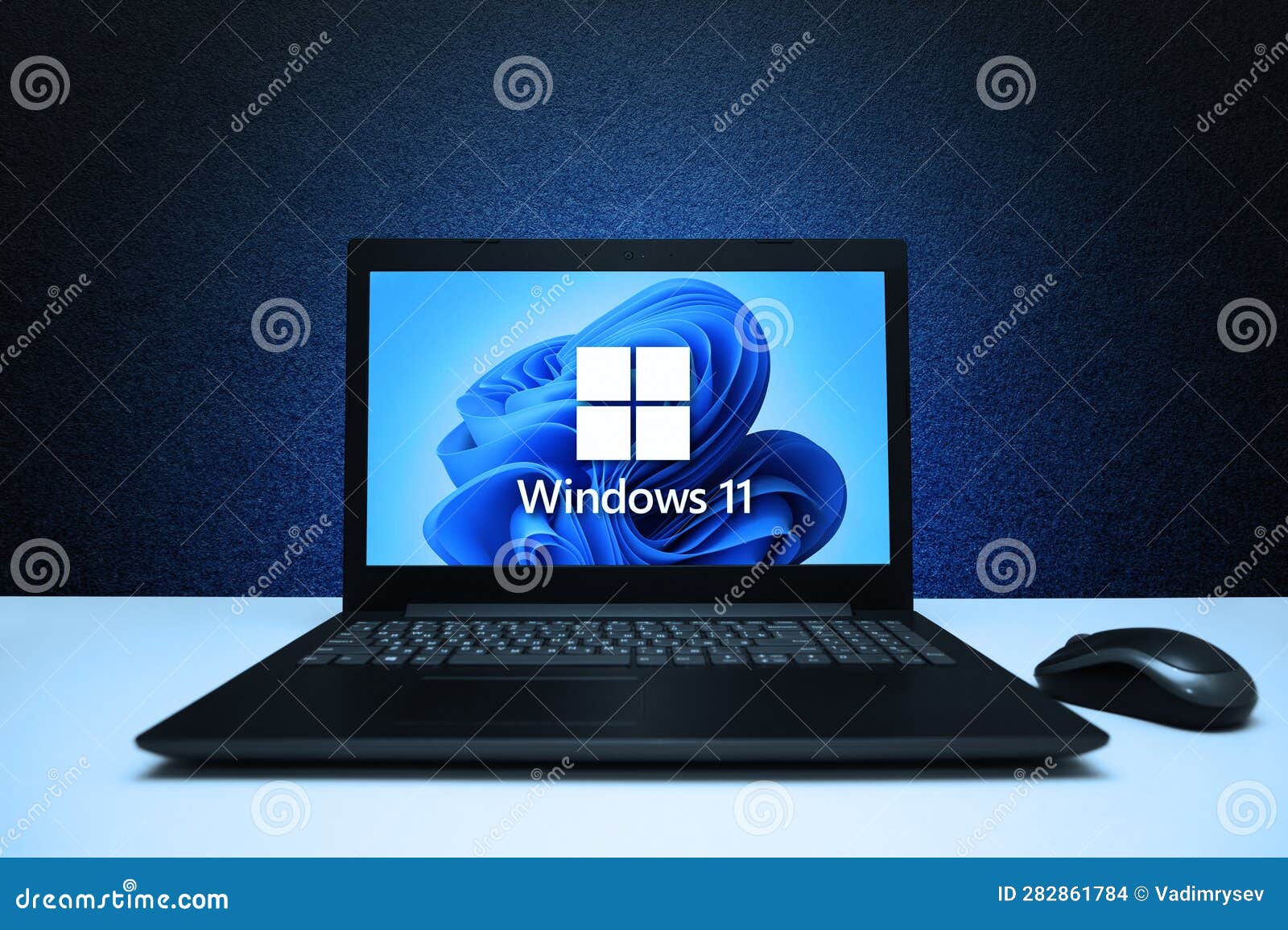 Windows 11 Logo on the Screen Laptop Computer with Mouse on Black ...