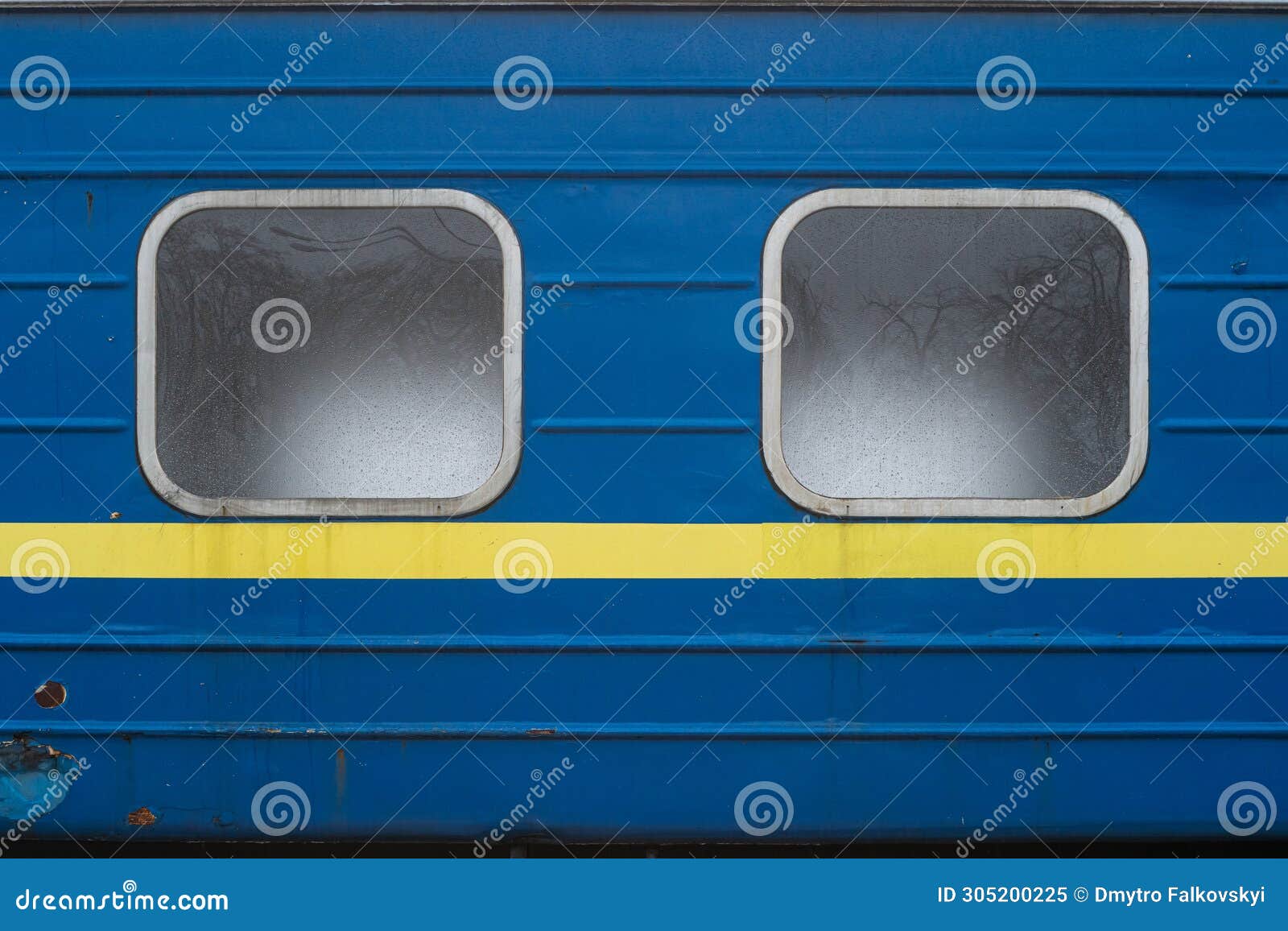 Windows of a Blue Passenger Car of a Train with a Yellow Stripe Below ...