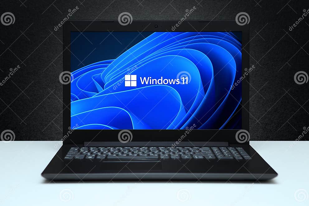 Windows 11 Logo on the Screen Laptop Computer Black Textured Wall with ...