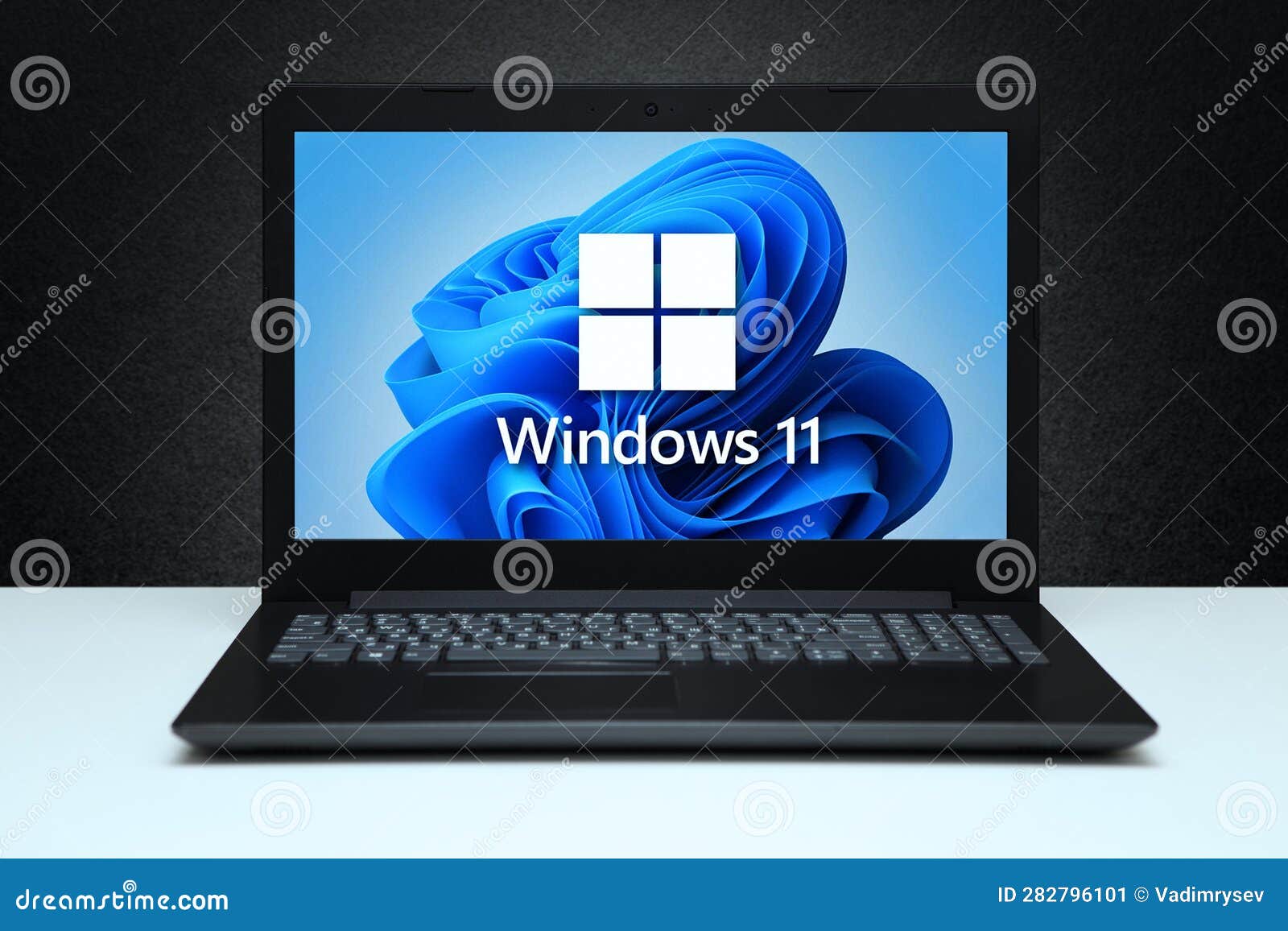 Windows 11 Logo on the Screen Laptop Computer Black Textured Wall with ...