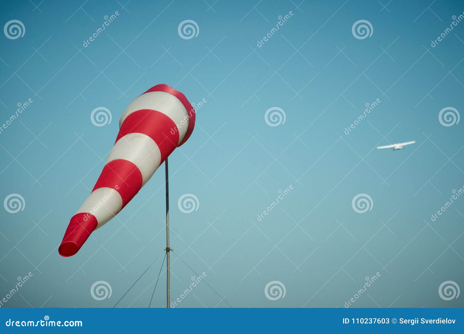 Windsock Blown by the Wind with Airplane on a Background Stock Image ...