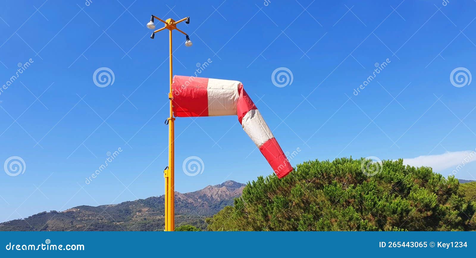 Windsock Indicator on Blue Sky and Mountains. Stock Image - Image of ...