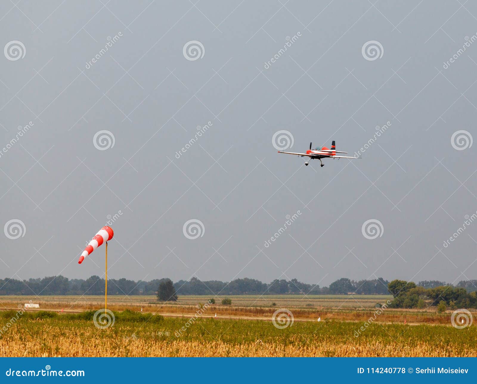A Windsock and a Plane Taking Off Stock Photo - Image of aircraft ...