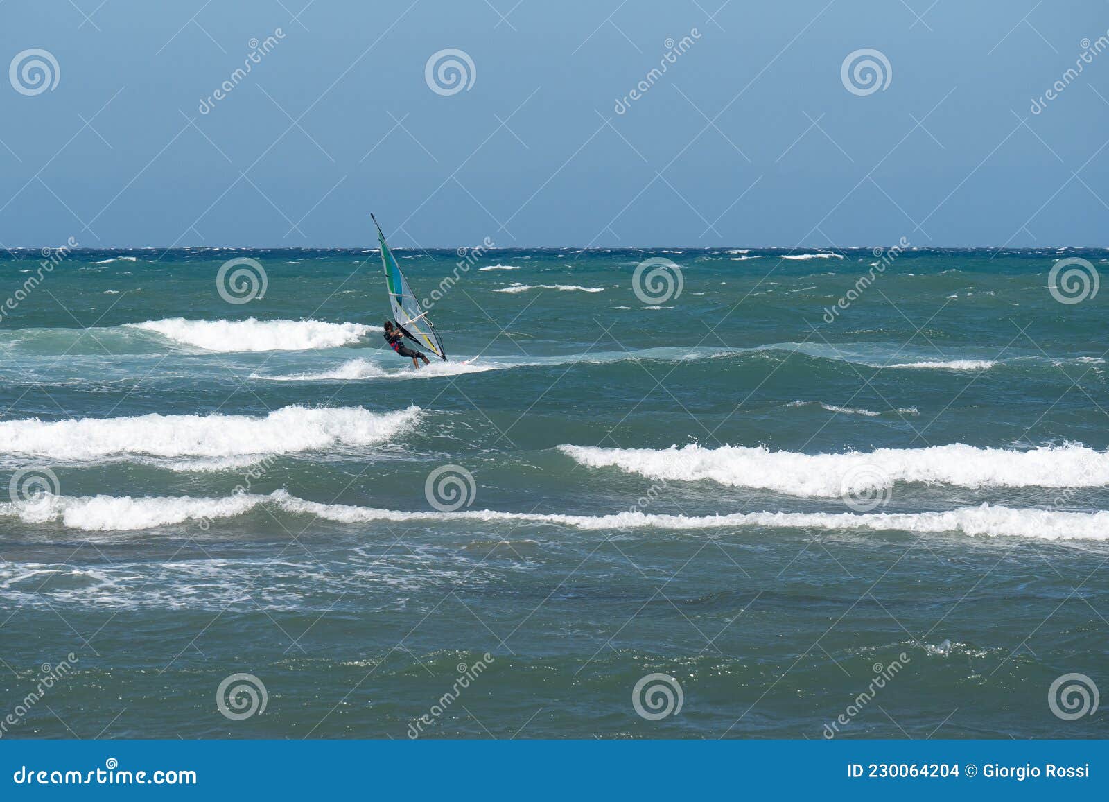 Windsurf Riding the Waves in a Choppy Sea Stock Photo - Image of ...