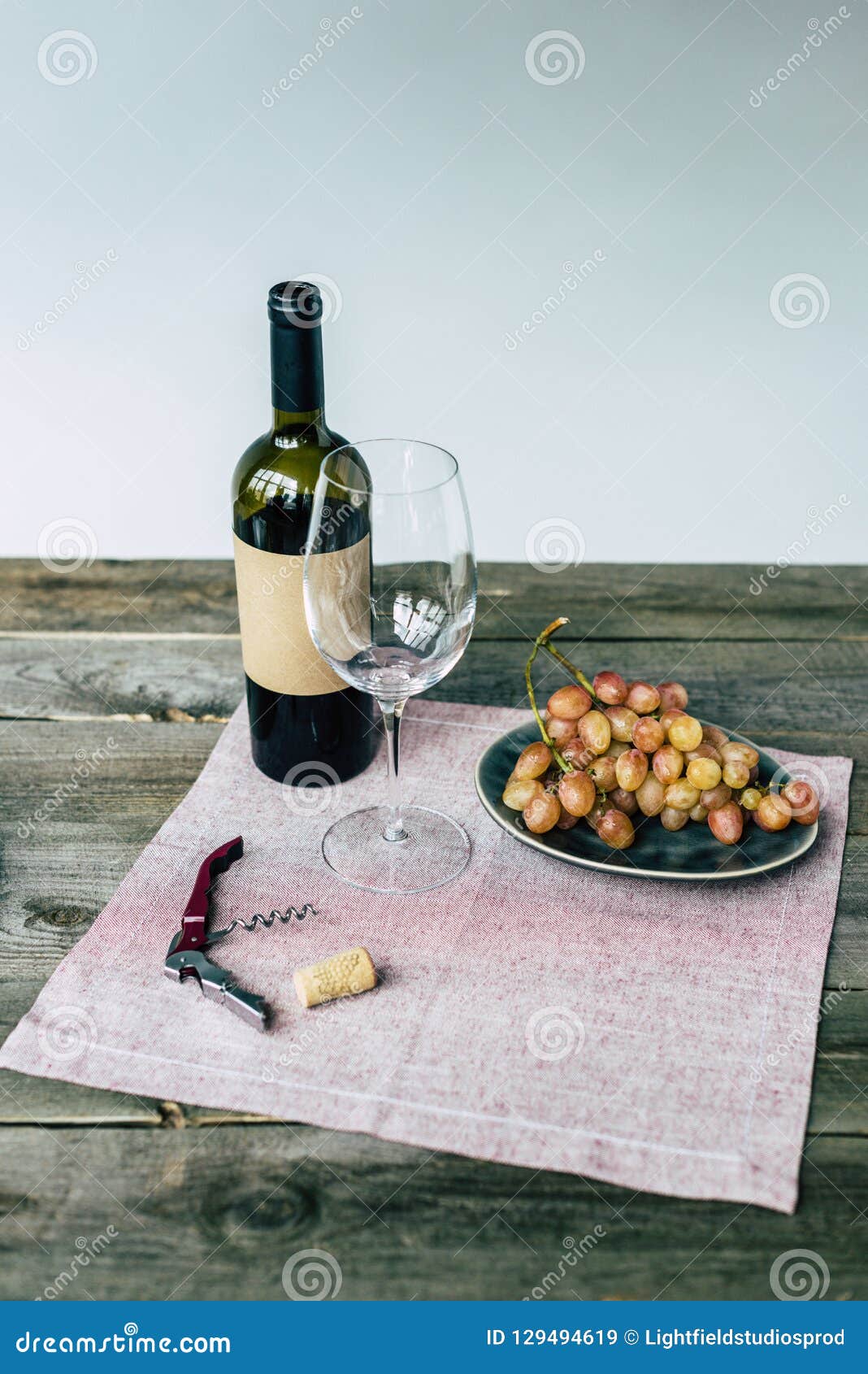 Wine Bottle with Empty Glass and Grapes on a Stock Image - Image of ...