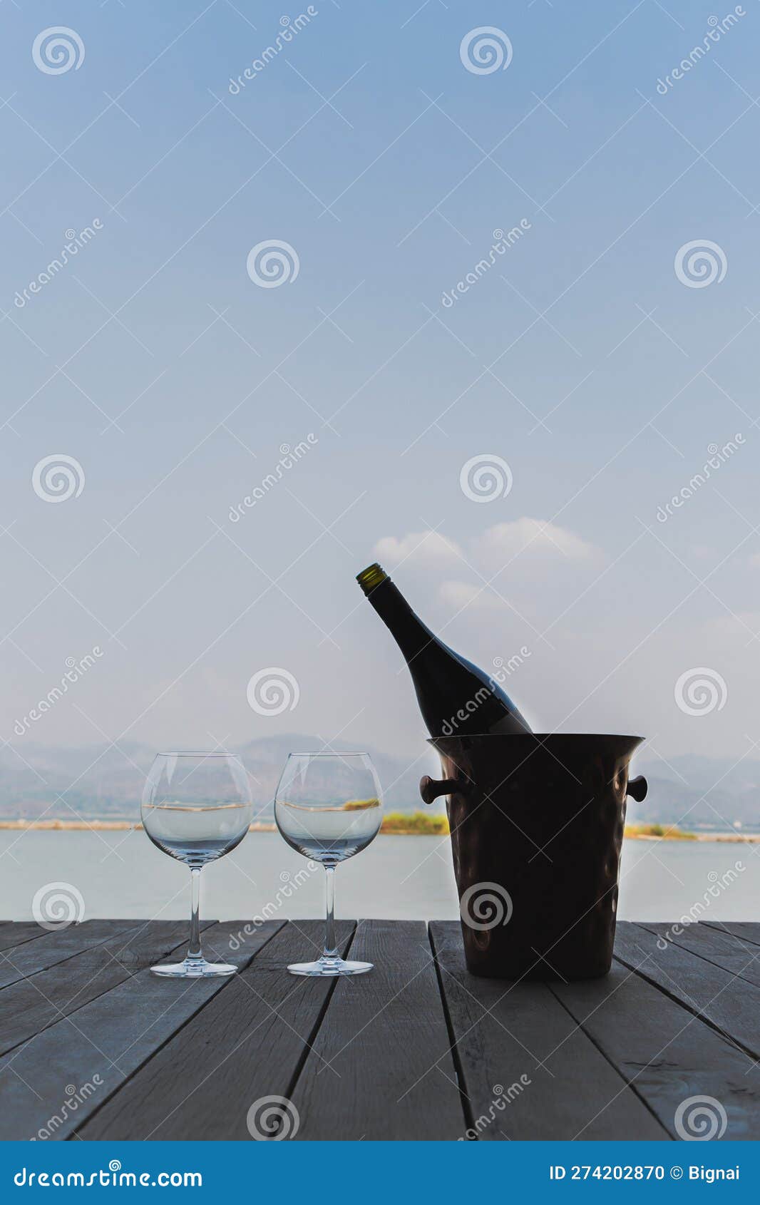 Wine Bottle with Two Glasses on Wooden Deck by the Lake. Stock Photo ...