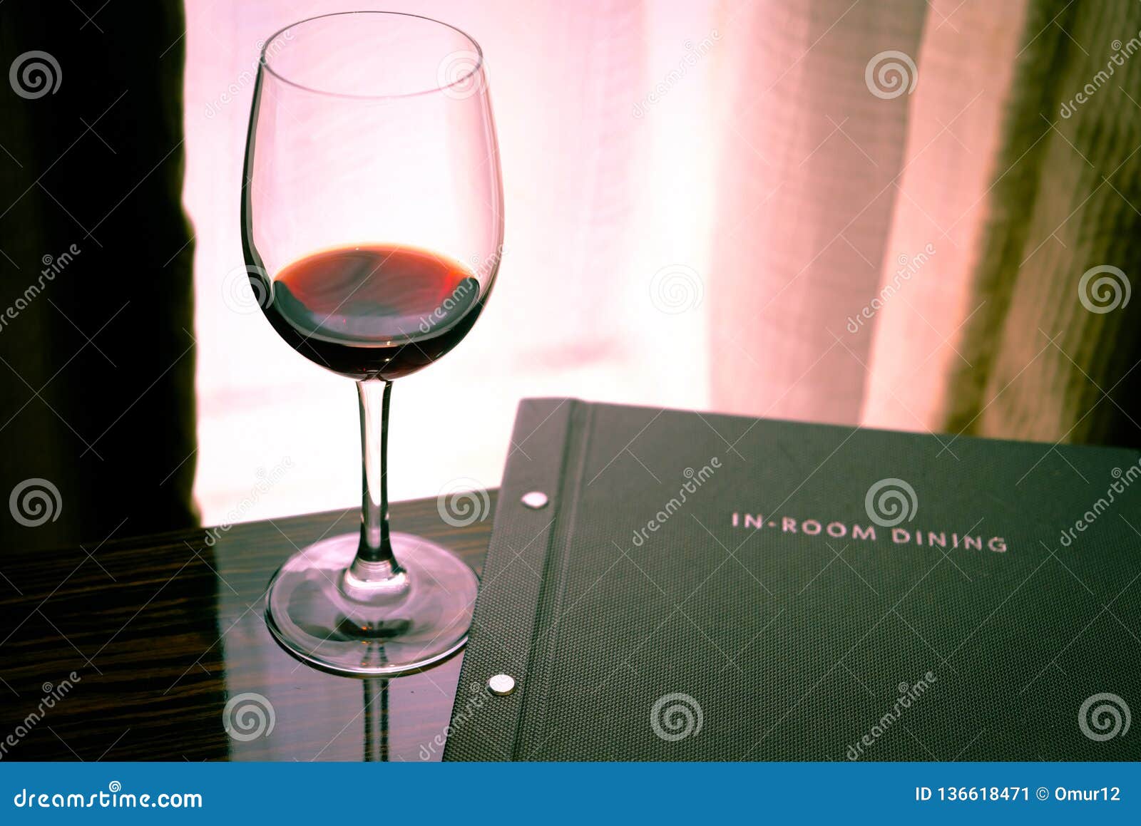 A Glass of Wine and a Dinner Menu on the Background of a Window and ...