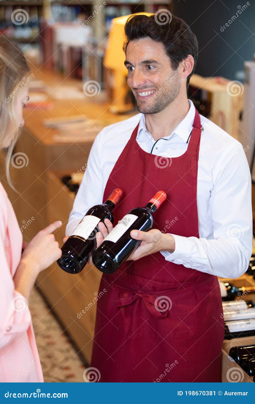 Wine Merchant Shows Bottles Red Wine To Customer Stock Image - Image of ...