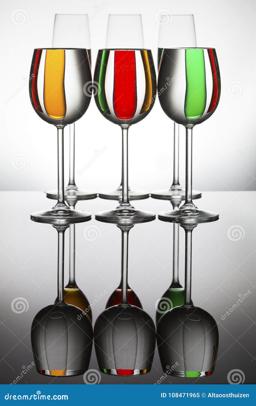 Wineglasses on a Shiny Surface with Different Colour Fluids that Stock ...