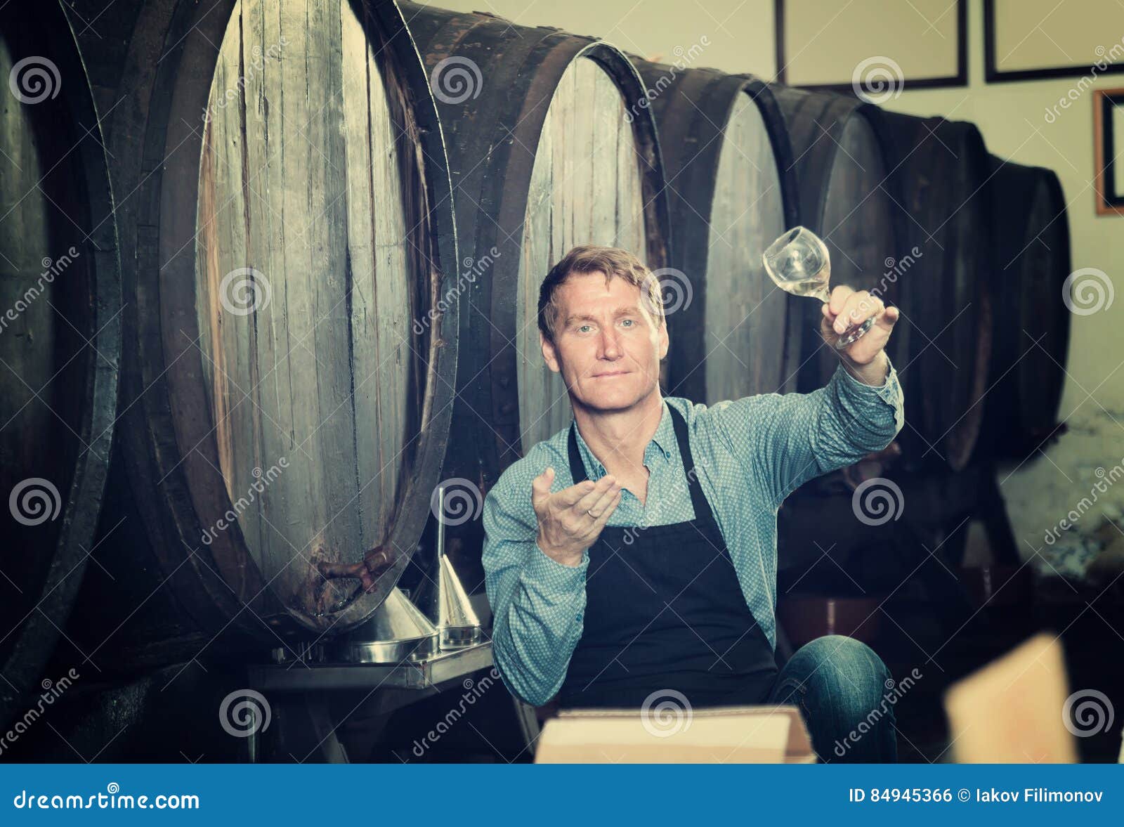 Winemaker Holding Glass of Wine in Cellar Stock Photo - Image of ...