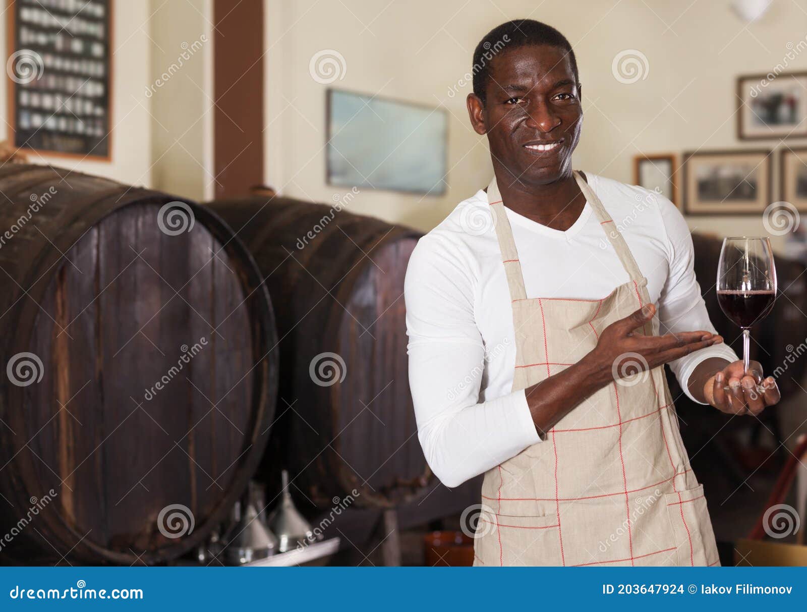 Winemaker Inviting To Wine Shop, Offering Glass of Wine Stock Photo ... Winemaker Inviting To Wine Shop, Offering Glass of Wine Stock Photo ...