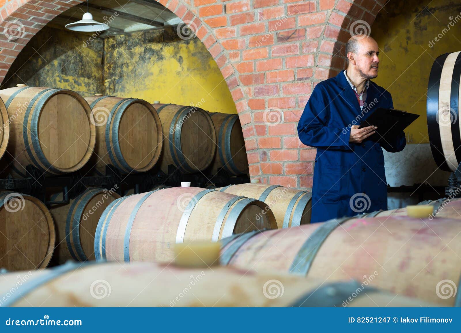 Winery Employee in Cellar with Woods Stock Image - Image of positive ...