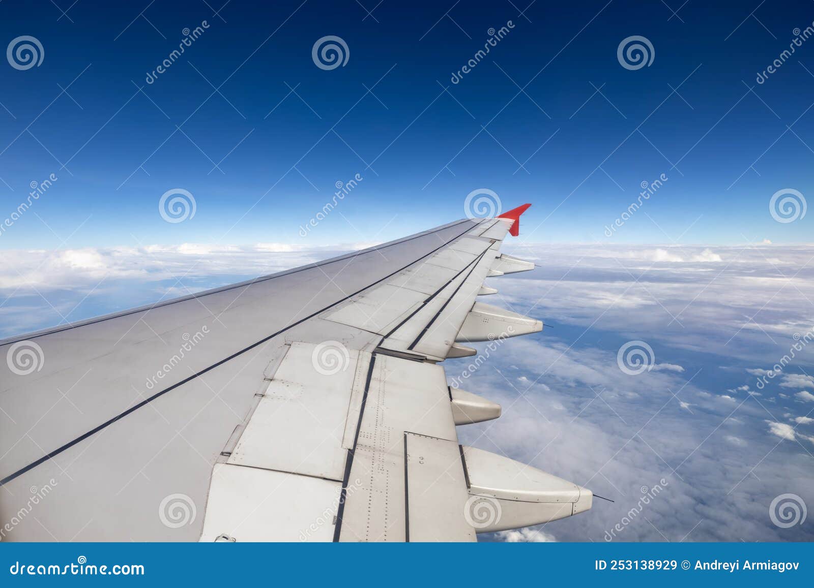 Wing of an Airplane Flying Above the Clouds Stock Image - Image of ...