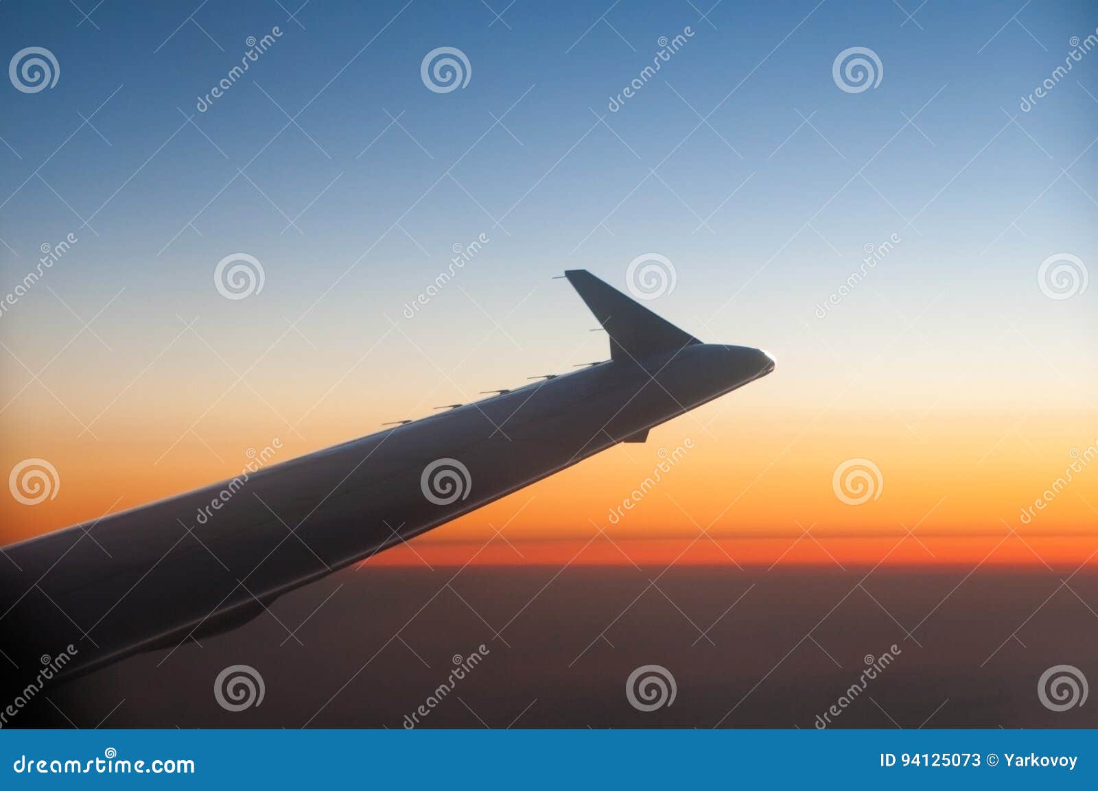 Wing of a Airplane at Sunset with Clouds Stock Image - Image of ...