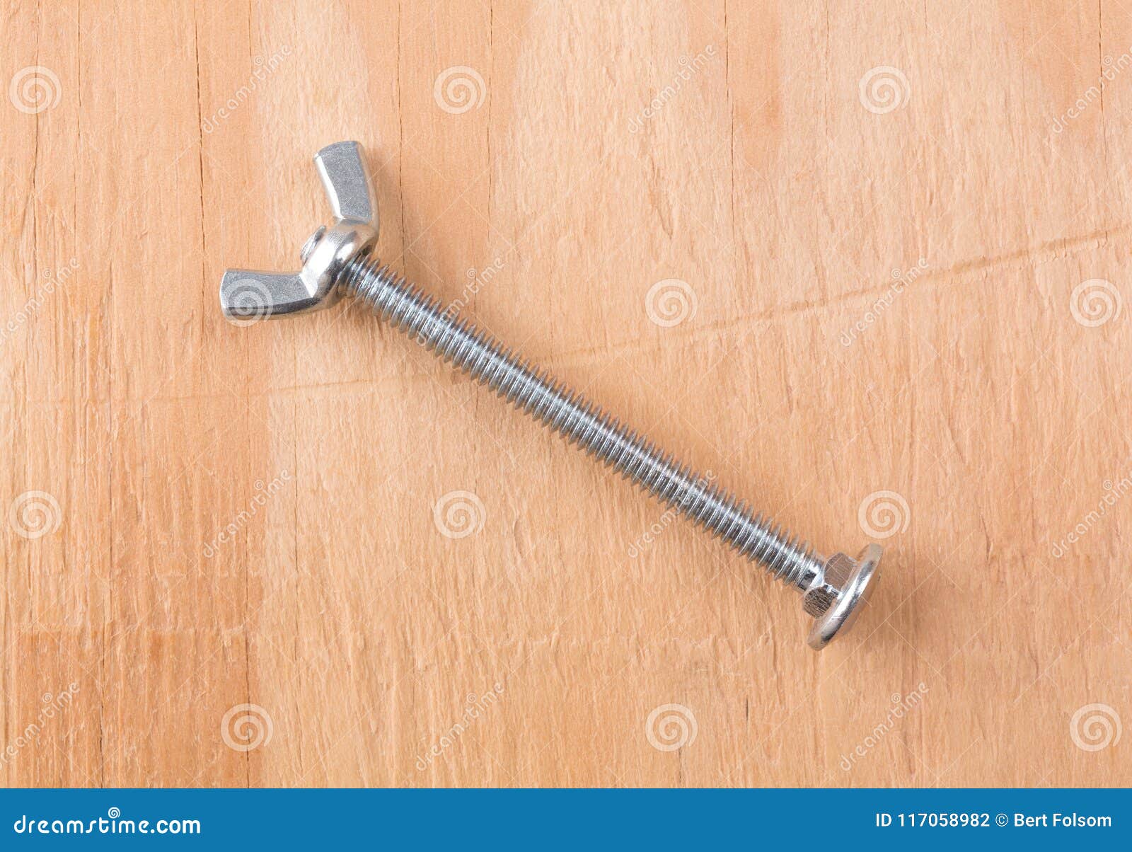 Wing Nut and Threaded Bolt on Plywood Stock Photo - Image of wing, used ...