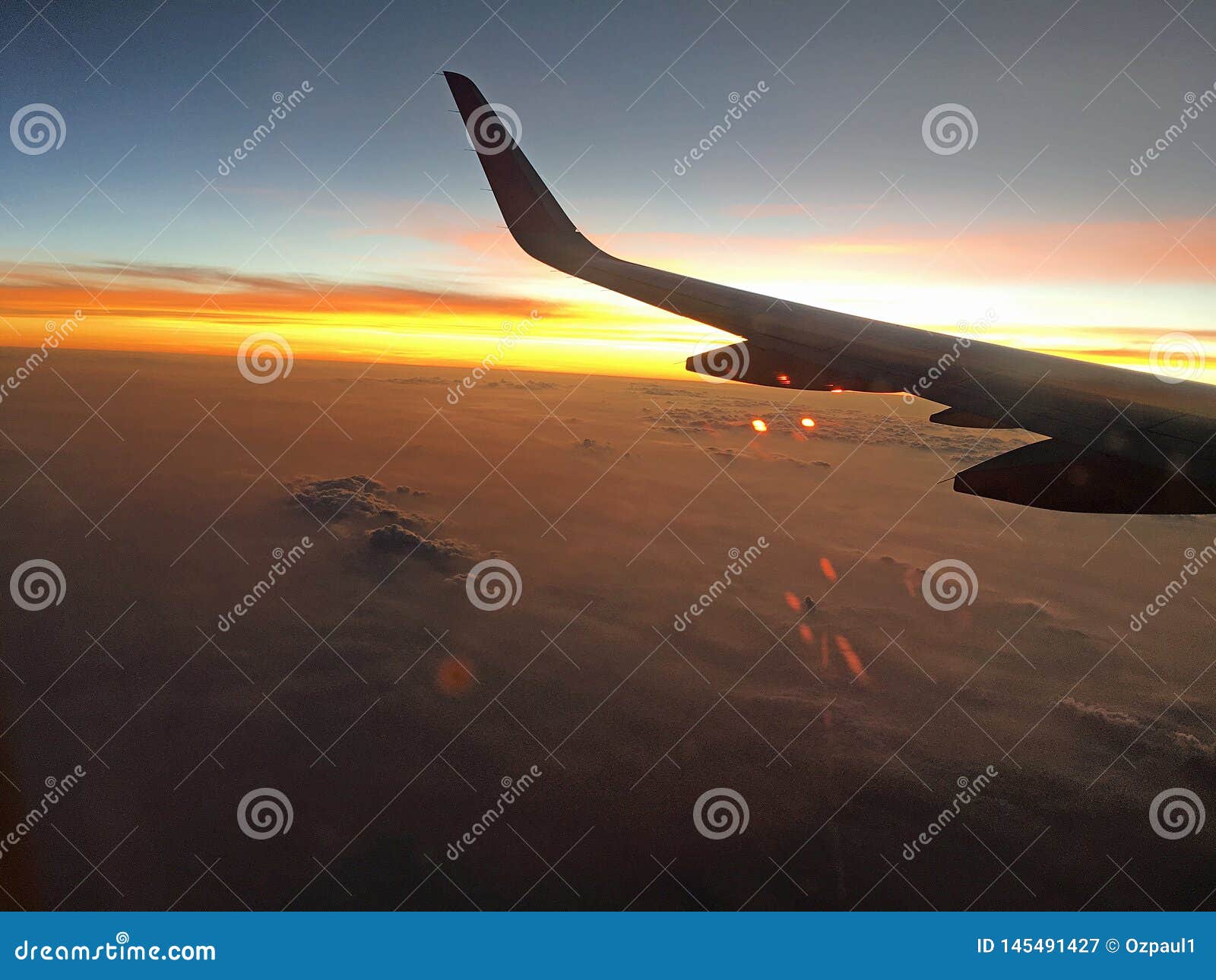 The Wing of a Plane in the Sunset Stock Image - Image of darkned, light ...
