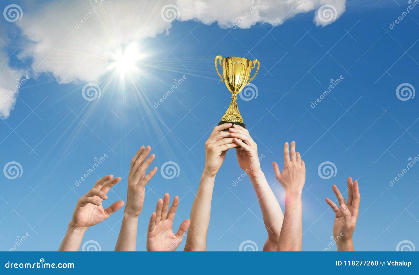 Winning Team is Holding Trophy in Hands. Many Hands Against Blue Sky ... Winning Team is Holding Trophy in Hands. Many Hands Against Blue Sky ...