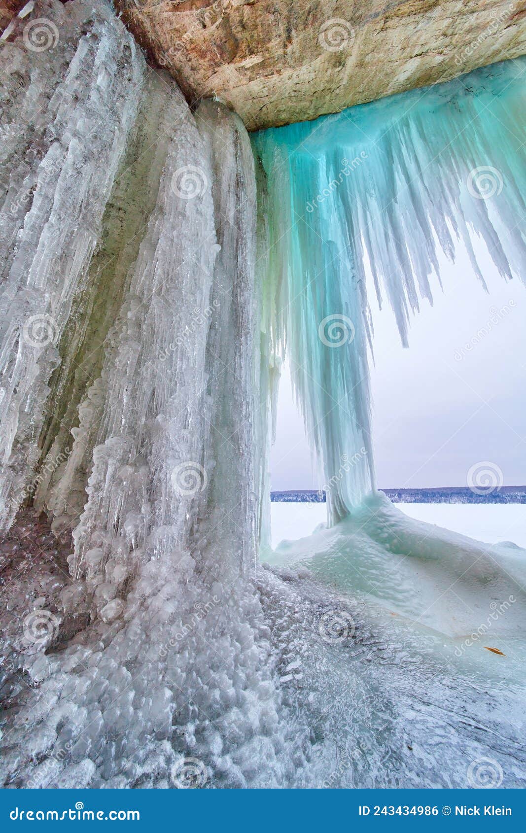 Winter Blue Sharp Icicles Hanging from Rocks Next To Lake Stock Photo ...