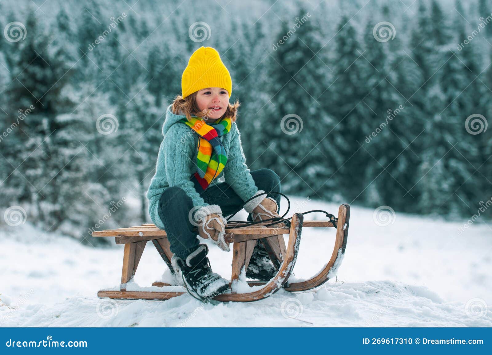 Winter Child Sliding on a Sled in Snowy Park. Stock Photo - Image of ...