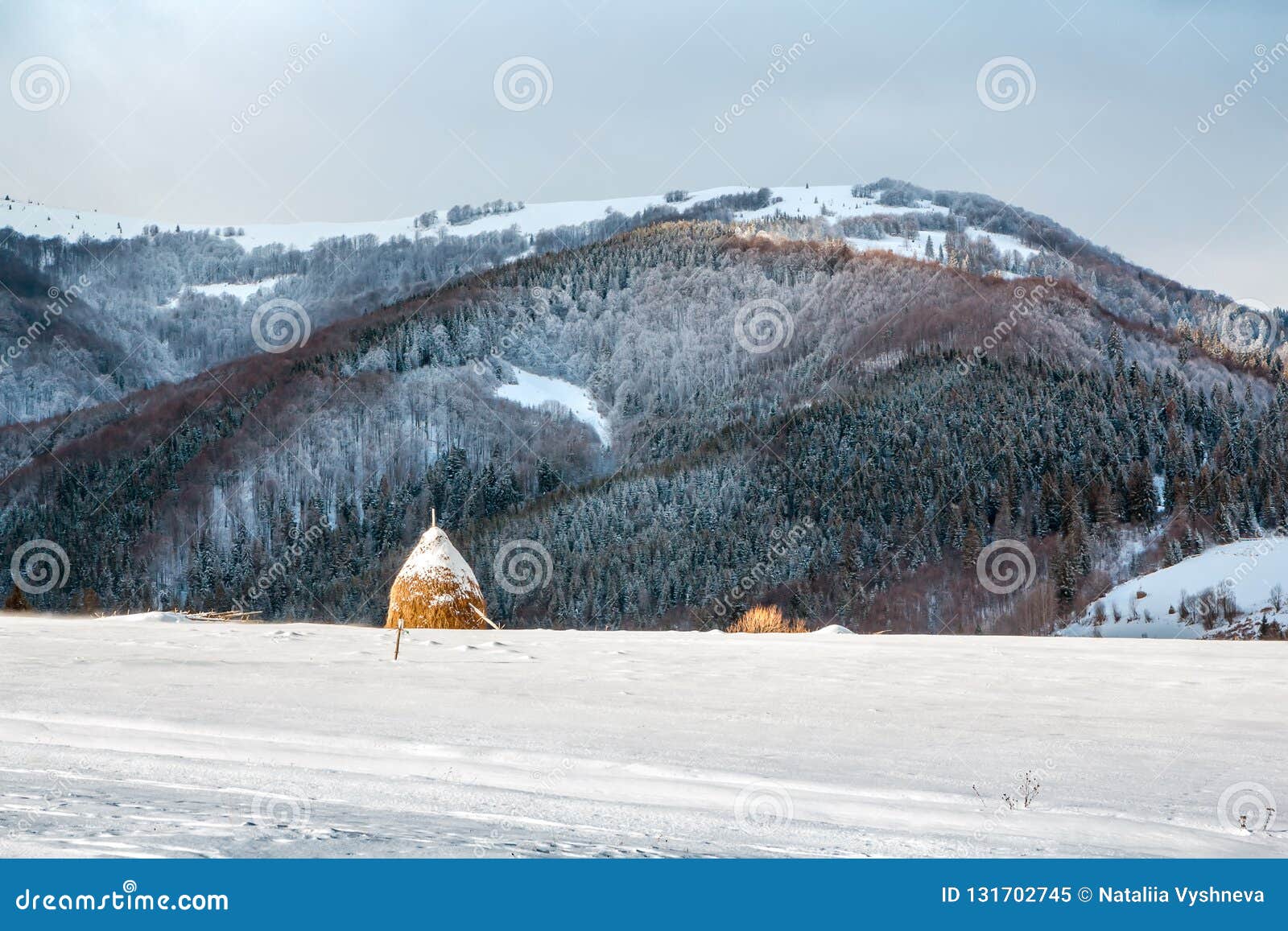 Winter Landscape, a Haystack on the Background of Snow-capped Mountains ...
