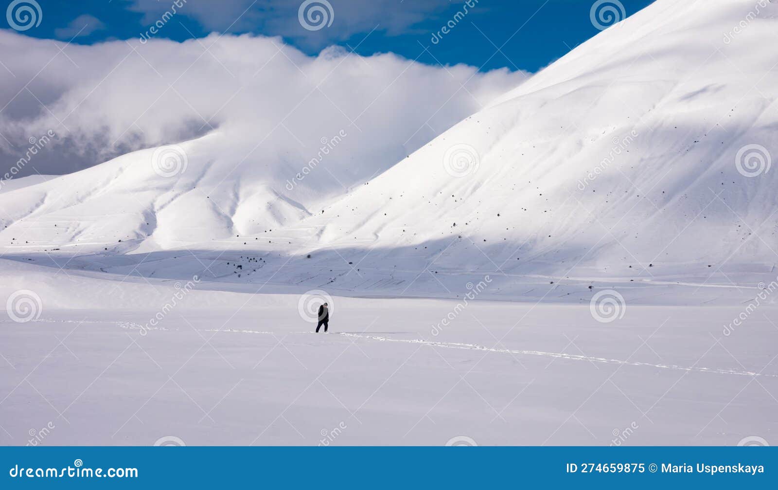 Winter Landscape, Man Walking in Snow Valley Surrounded by Hills Stock ...