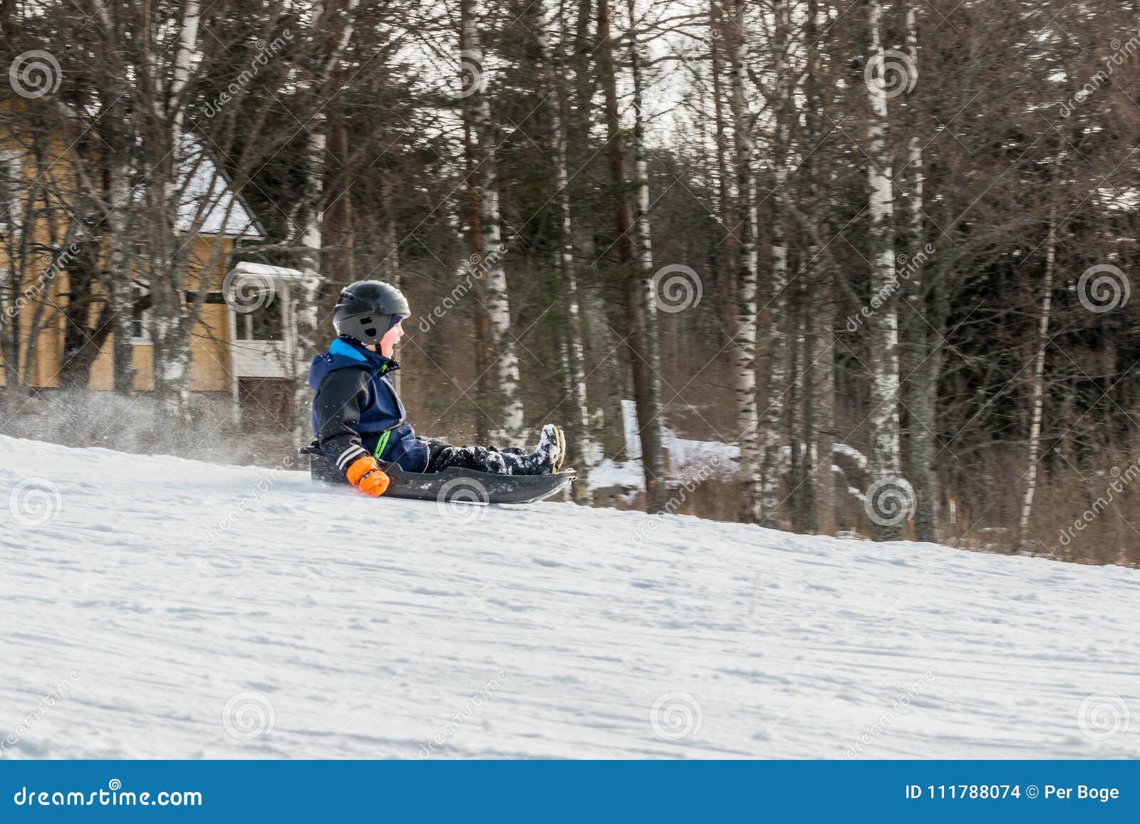 A Child Riding a Sledge Downhill, Profile View. Stock Photo - Image of ...