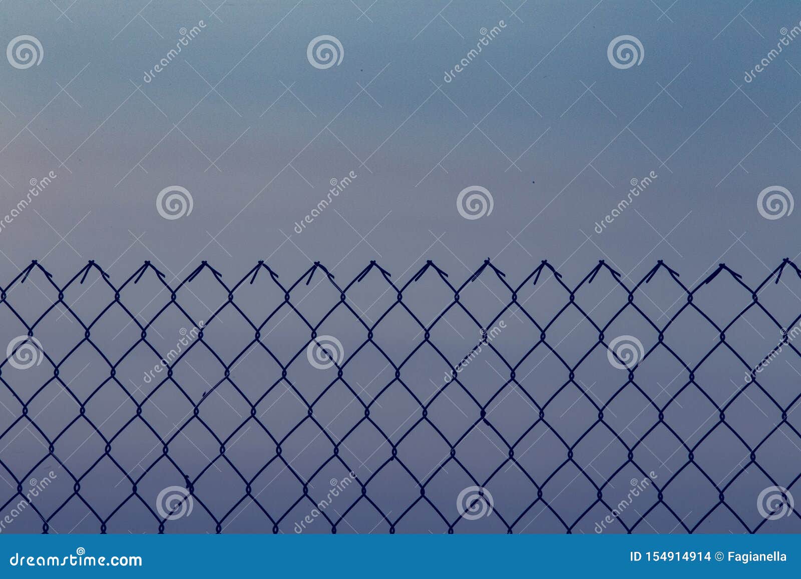 Wire Fence Close Up with Colored Sky Background; Separation or ...