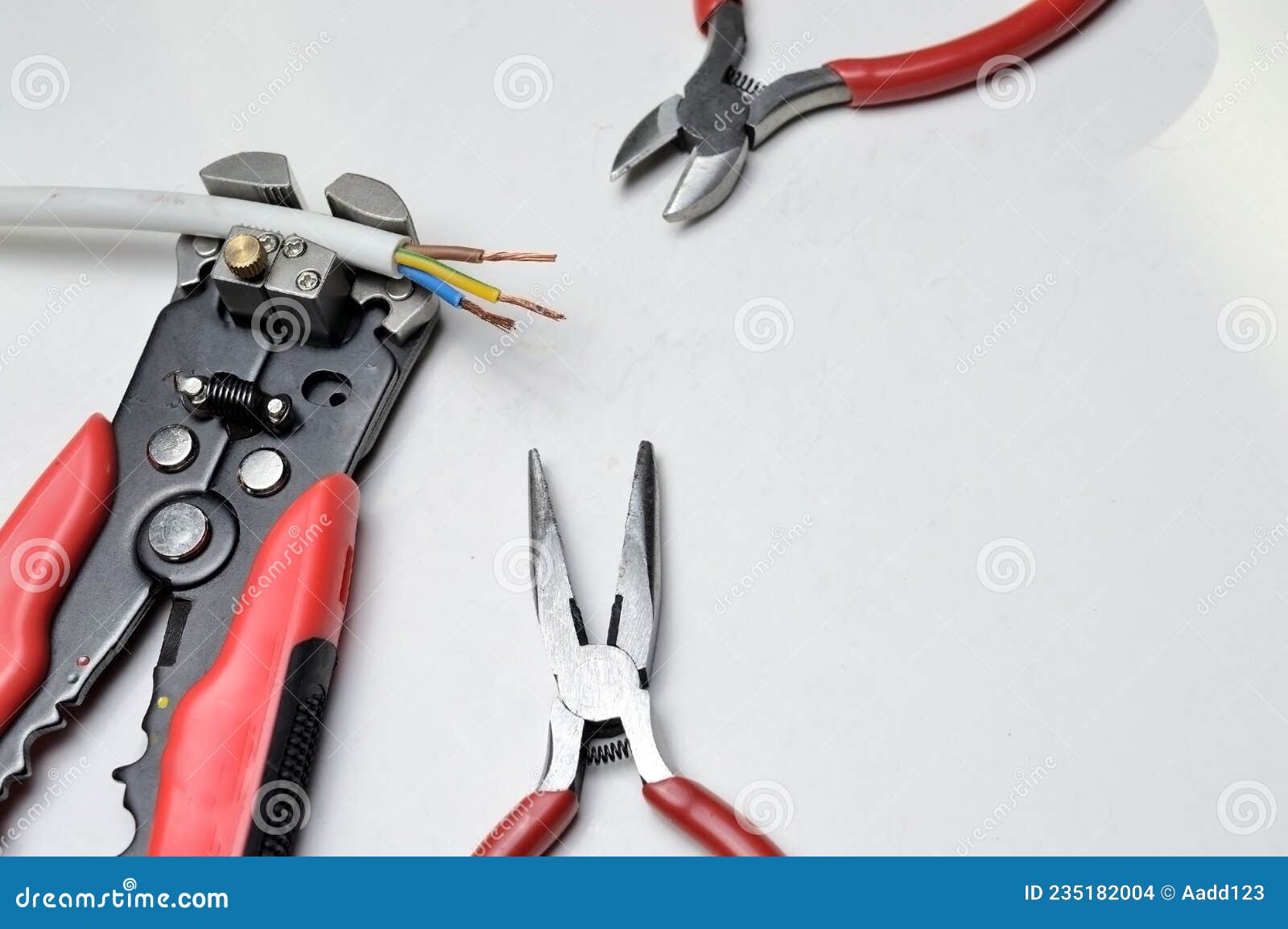 Wire Stripper, Shielded Three-core Wire and Wire Cutters on a White ...