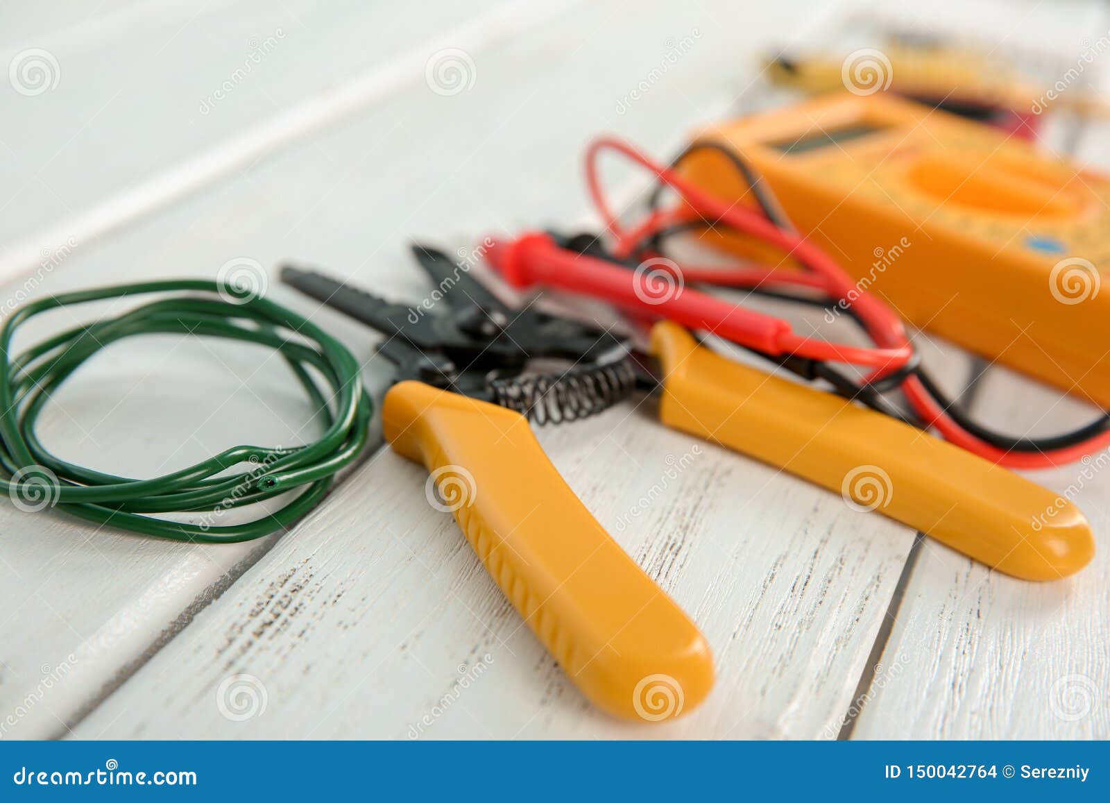 Wire Stripper and Wire on Wooden Table, Closeup. Electrical Tools Stock ...